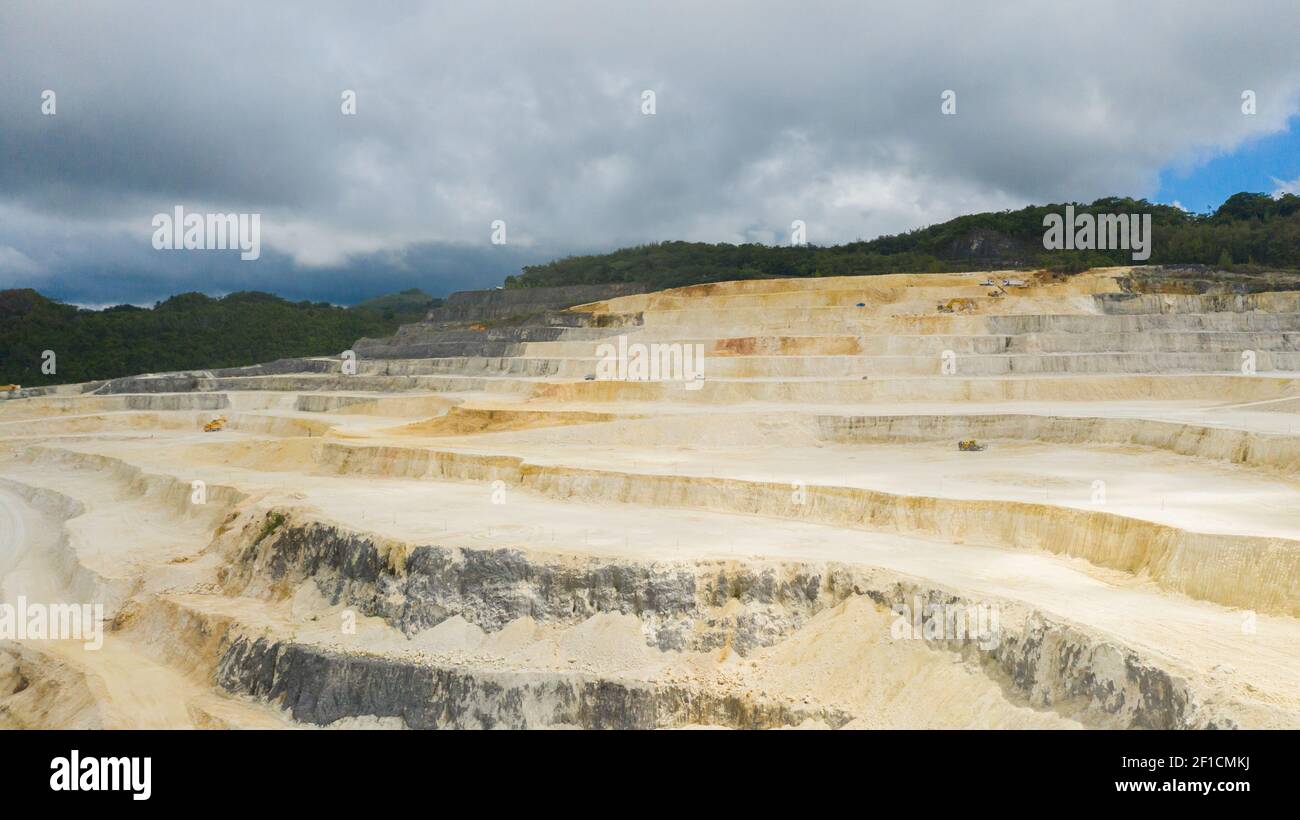 Aerial view of limestone quarry in the mountains among the rainforest ...