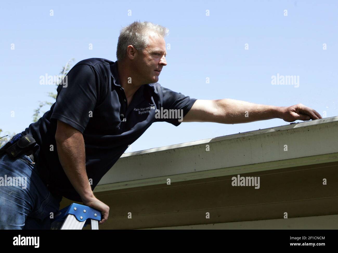 Robert Lenney, of Rain Harvesting Systems, checks the special ...