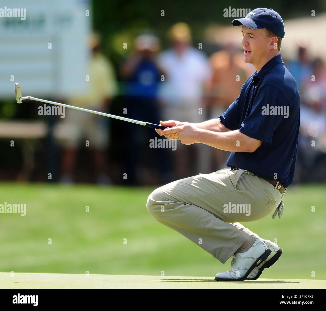 NFL quarterback Peyton Manning reacts to his missed putt on the 18th ...