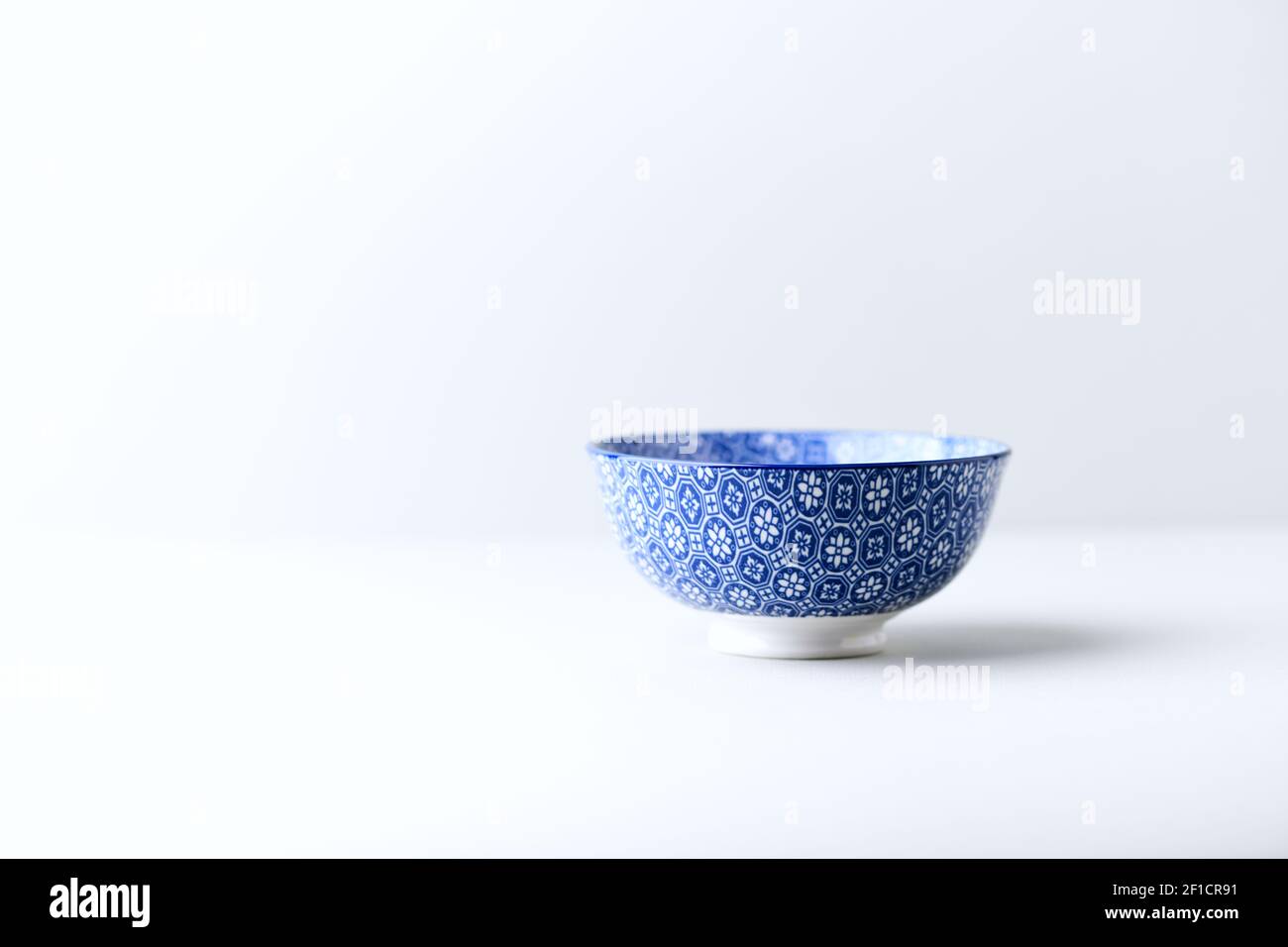 Traditional ceramic bowl on bright background. Copy space Stock Photo ...
