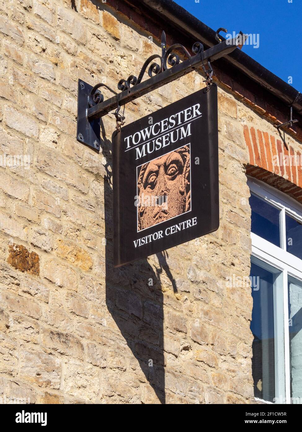 Close up of the sign for Towcester Museum, featuring a Roman face ...
