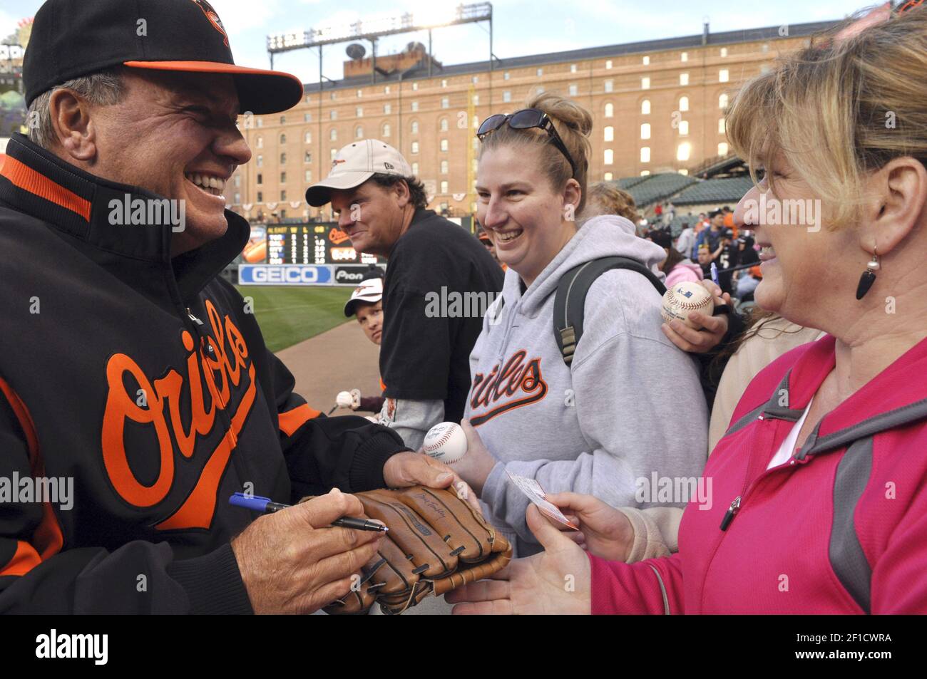 Baltimore Orioles manager Dave Trembley autographs a ball for Mary Long ...