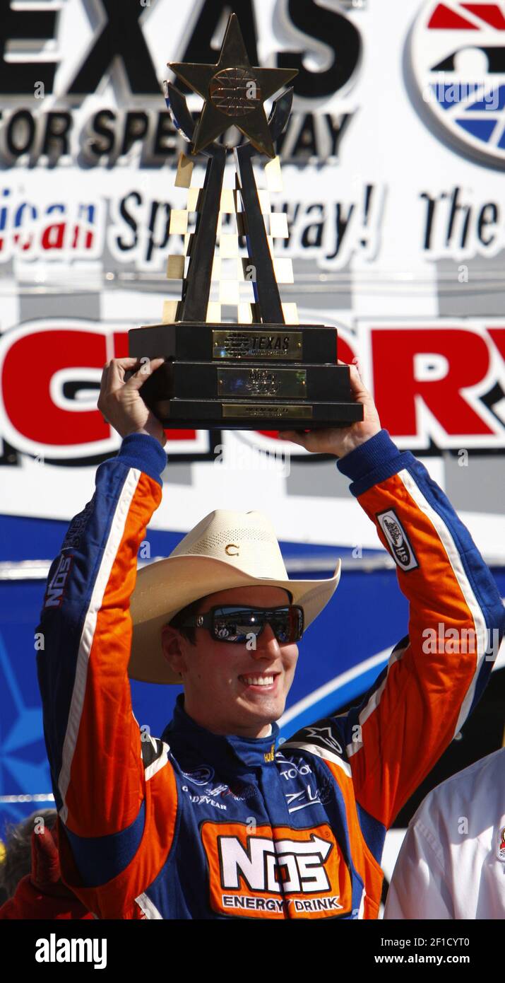 Kyle Busch holds the trophy aloft after winning the NASCAR Nationwide ...