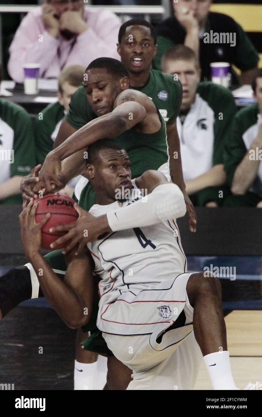 Michigan State's Delvon Roe (10) fouls Connecticut's Jeff Adrien (4 ...