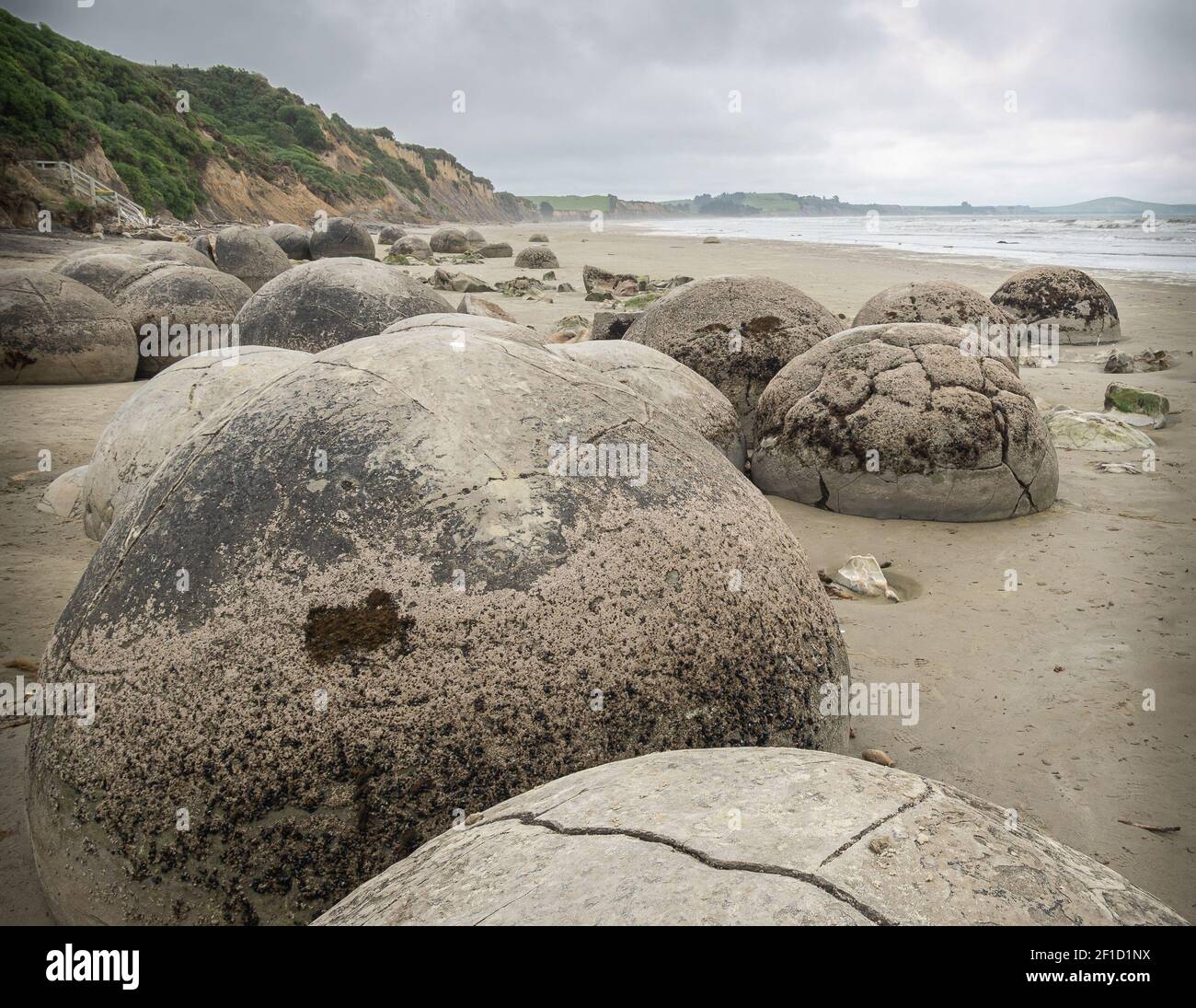 Beach full of huge stone boulders. Shot on overcast day on Moearaki ...