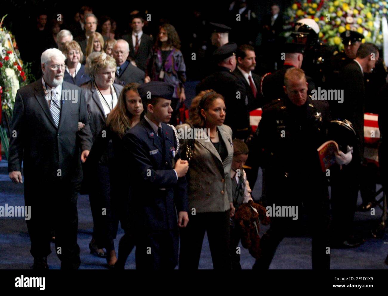 The family of Sgt. Mark Dunakin is escorted to their seats on Friday ...