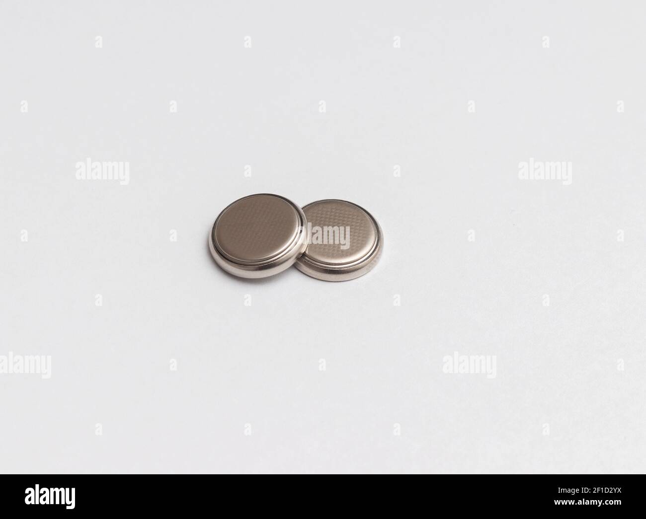 two button cell or disk cell batteries isolated on white background ...