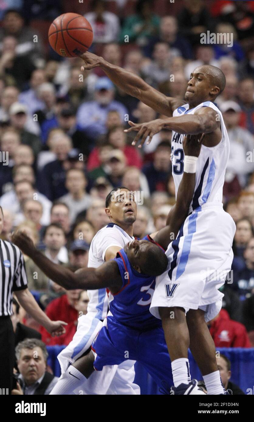 Villanova's Dante Cunningham blocks a shot attempt by American's Derrick Mercer as Scottie ...