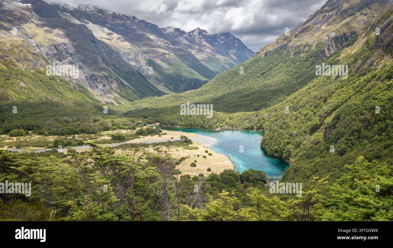 Pristine alpine lake hidden in the mountain valley, shot at Blue Lake ...