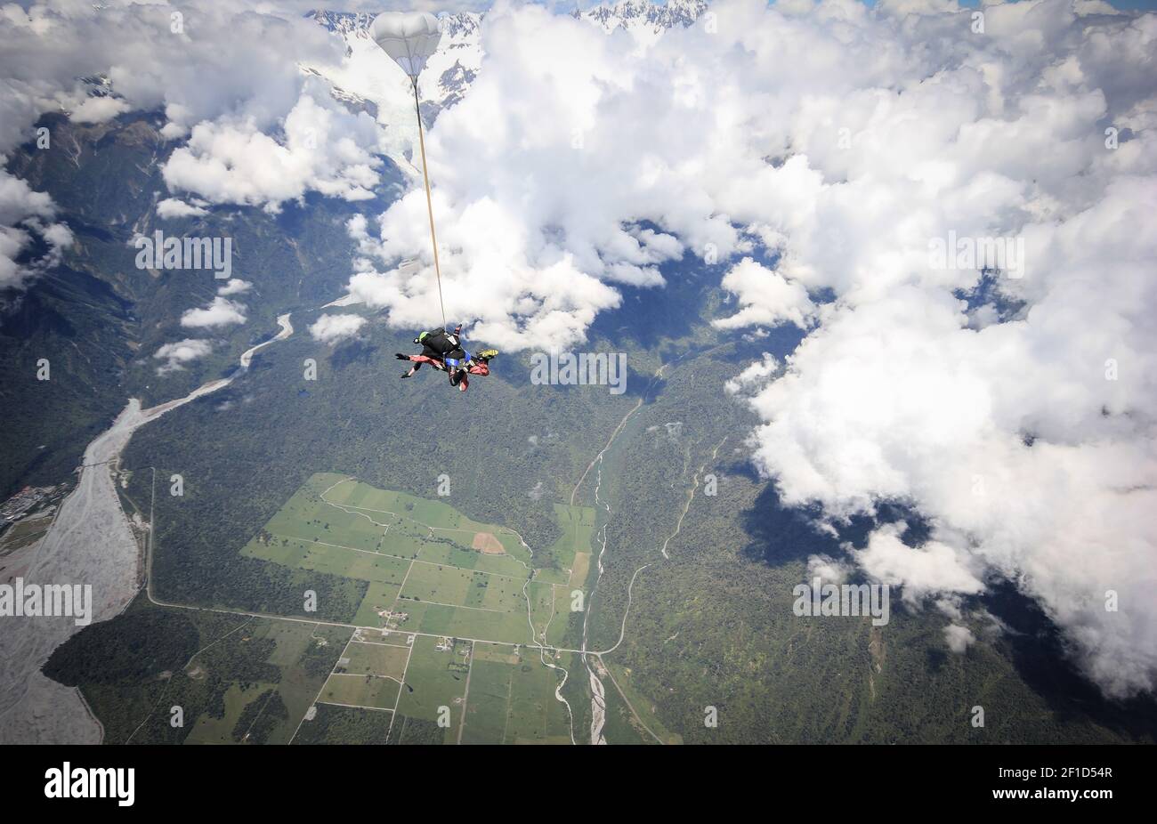 Skydiving in tandem,seconds after jumping out of plane, tilted shot ...