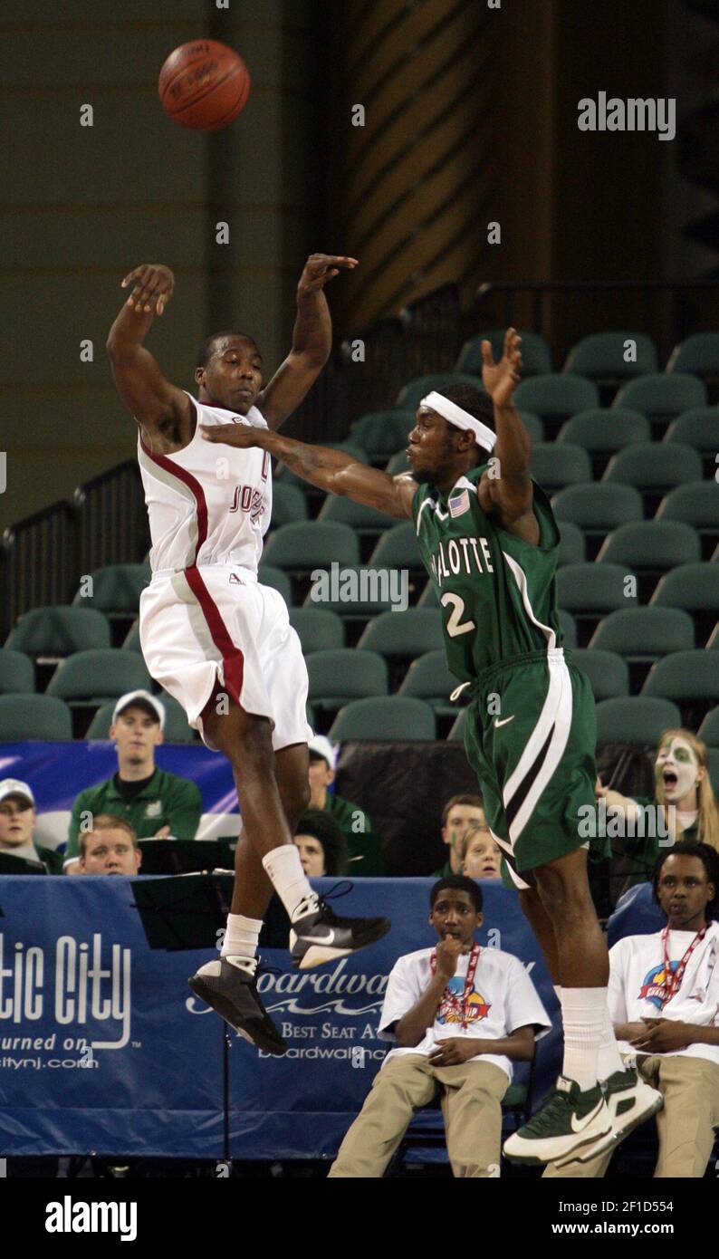 Saint Joseph's Tasheed Carr, left, passes the basketball past Charlotte ...