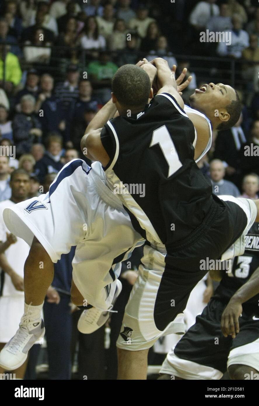 Villanova's Corey Fisher is hammered by Providence' Jeff Xavier during ...