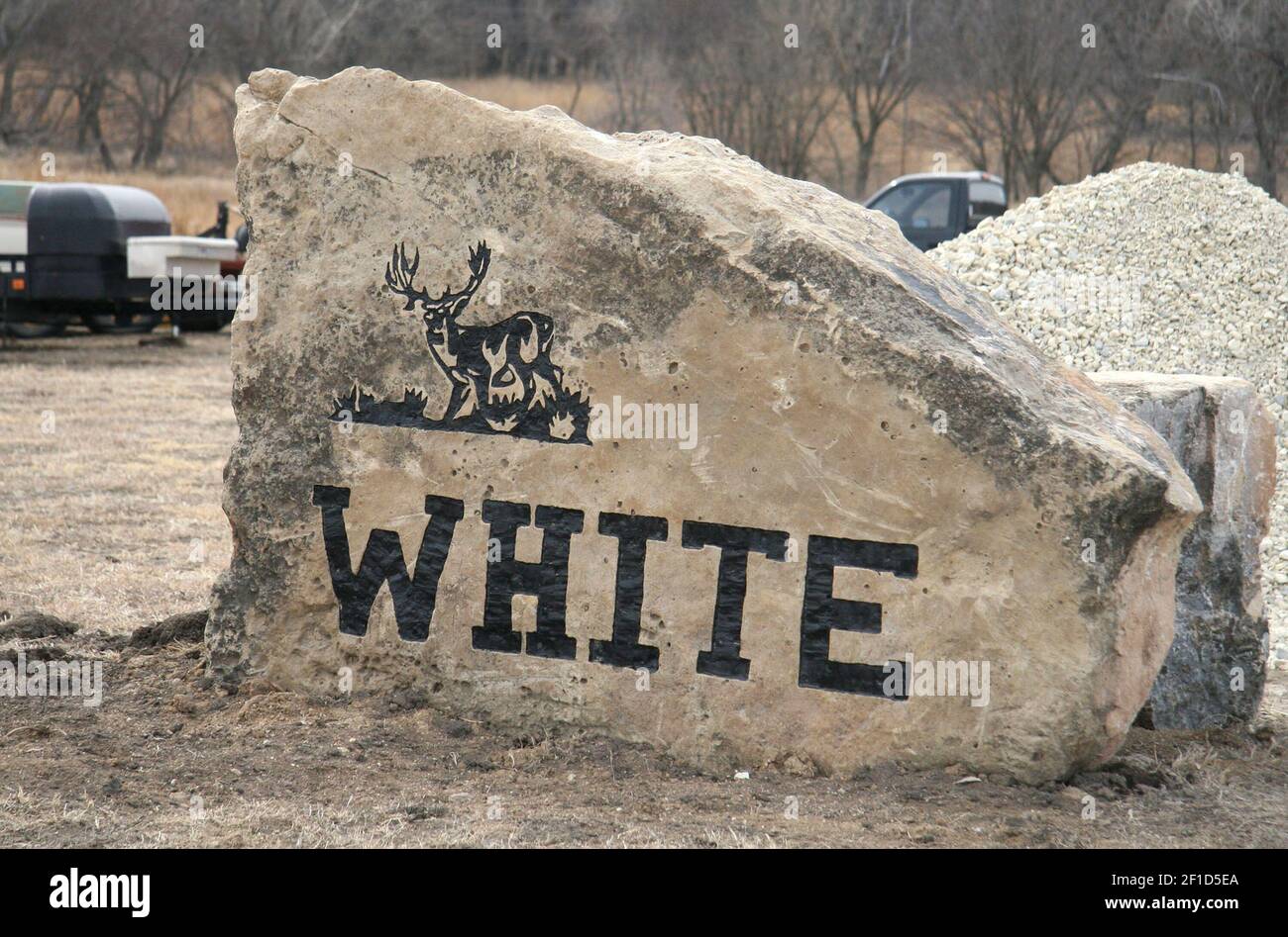 The image of a whitetail buck cut into stone shows the White brother's ...