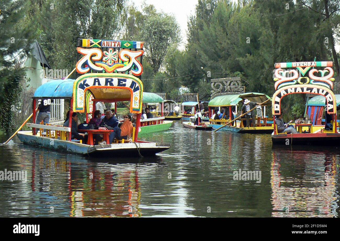 Painted wooden boats, called trajineras, crowd the canals of Xochimilco ...