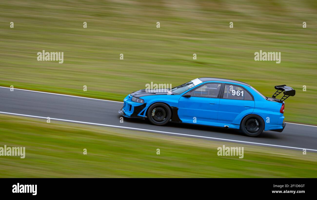 A panning shot of a racing car as it circuits a track Stock Photo - Alamy