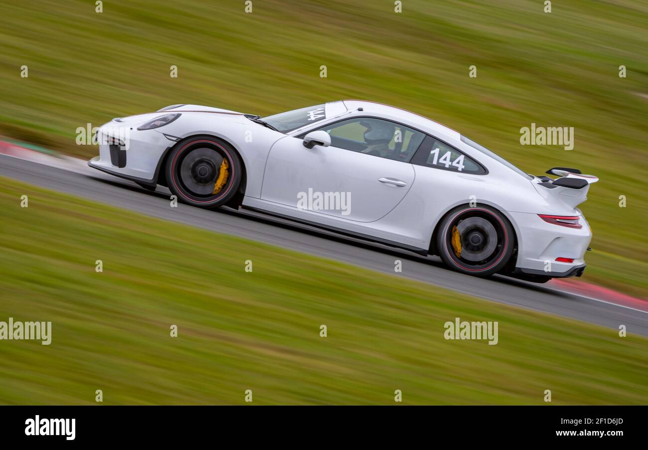 A panning shot of a racing car as it circuits a track Stock Photo - Alamy