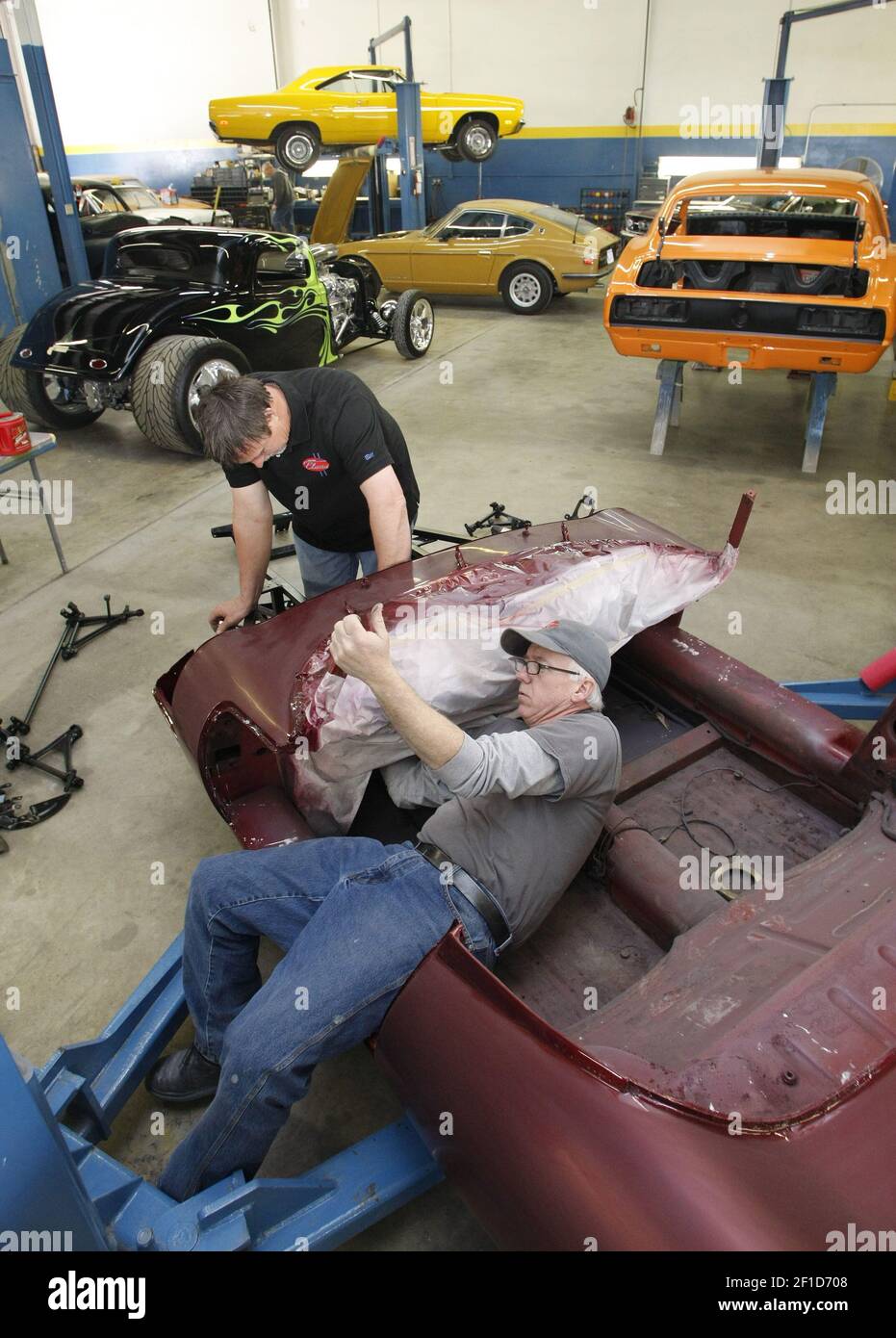 Kustom Classics partners Bill Cate, left, and Bobby Mikus install the ...