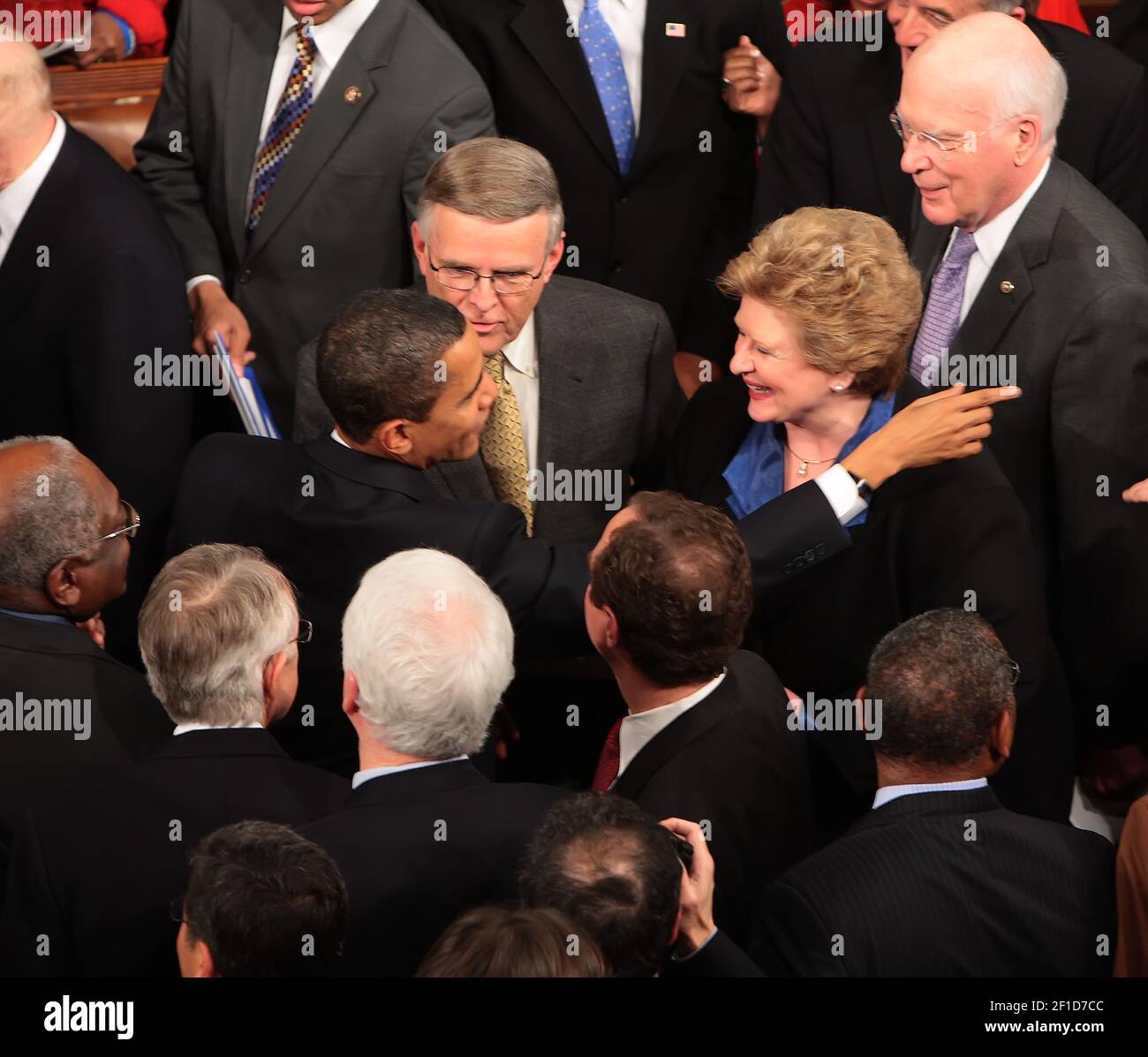 President Barack Obama is surrounded by members as he leaves a joint ...