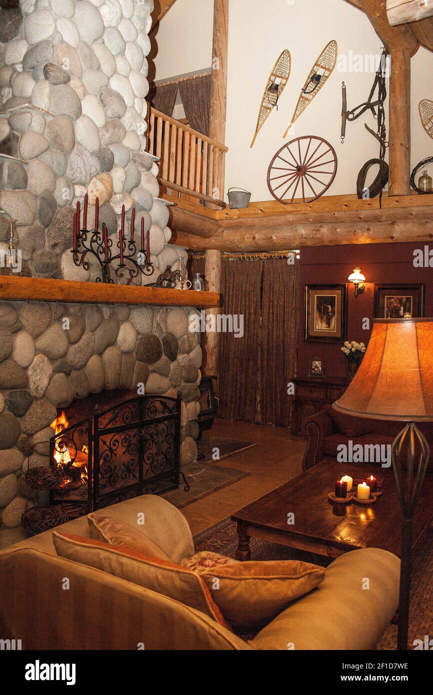 River stones and Canadian peeled spruce logs dominate the living room ...