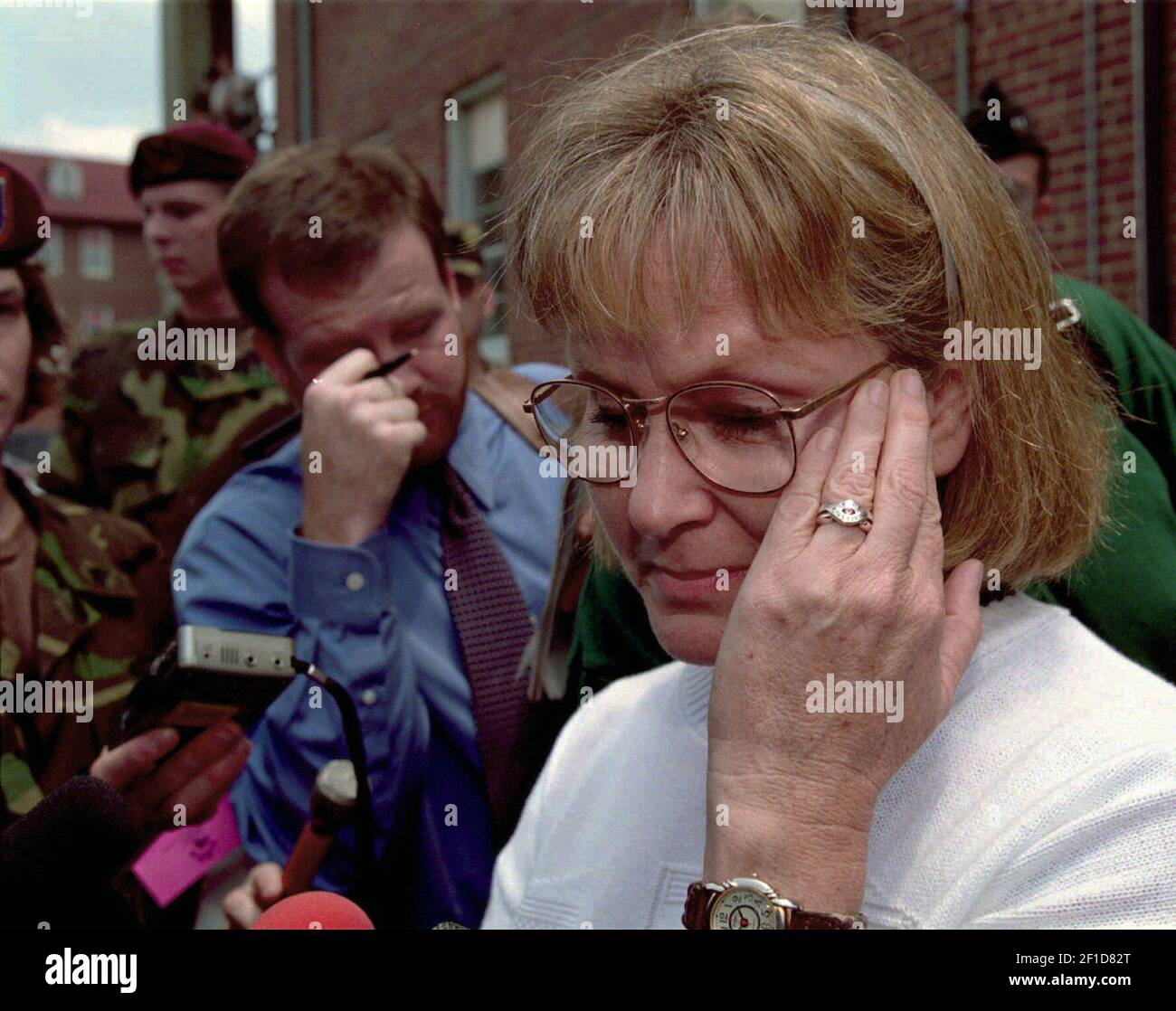 Diane Badger, widow of Maj. Stephen Mark Badger, wipes a tear from her ...