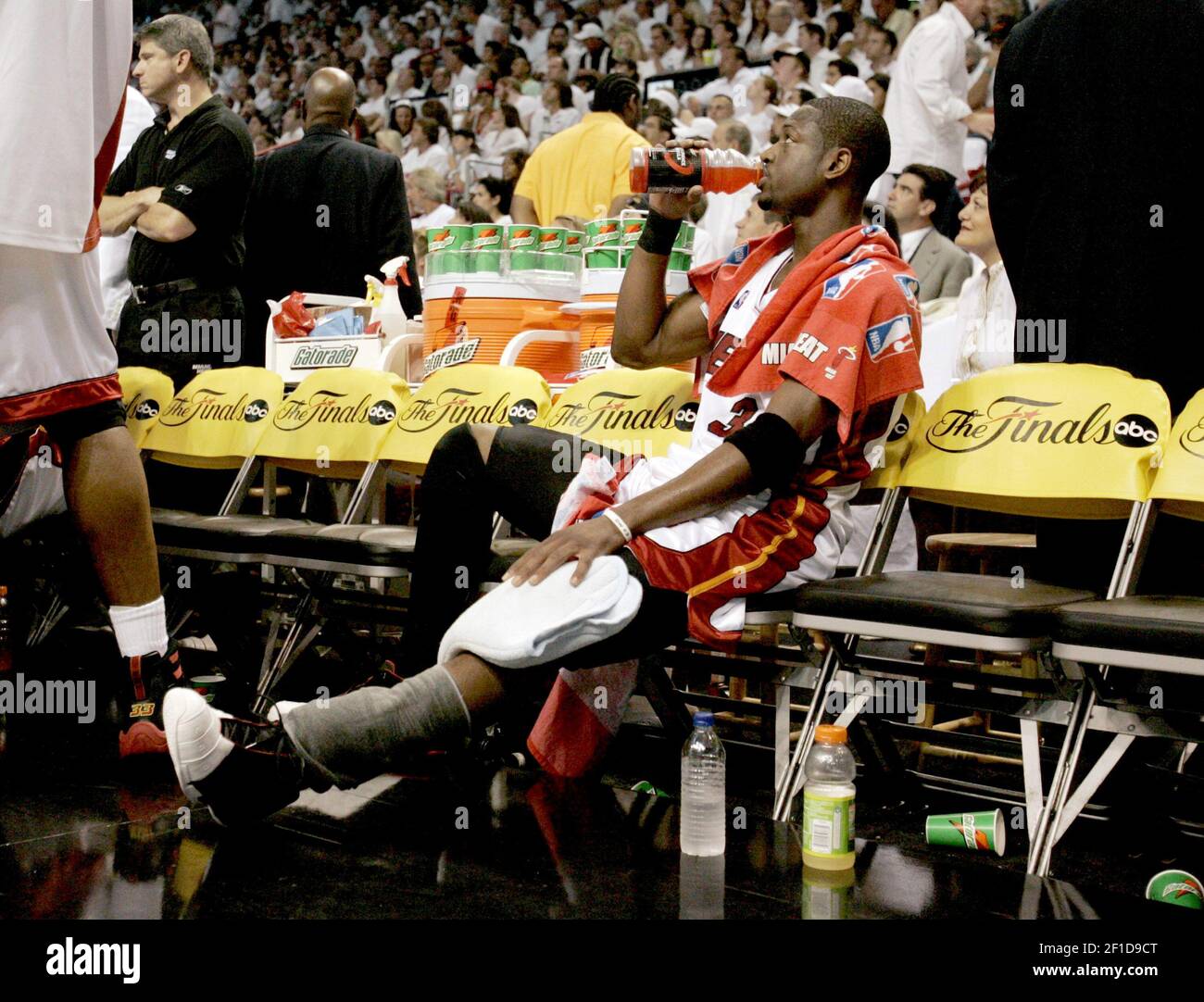 Miami Heat's Dwyane Wade (3) rests his knee on the bench during the ...