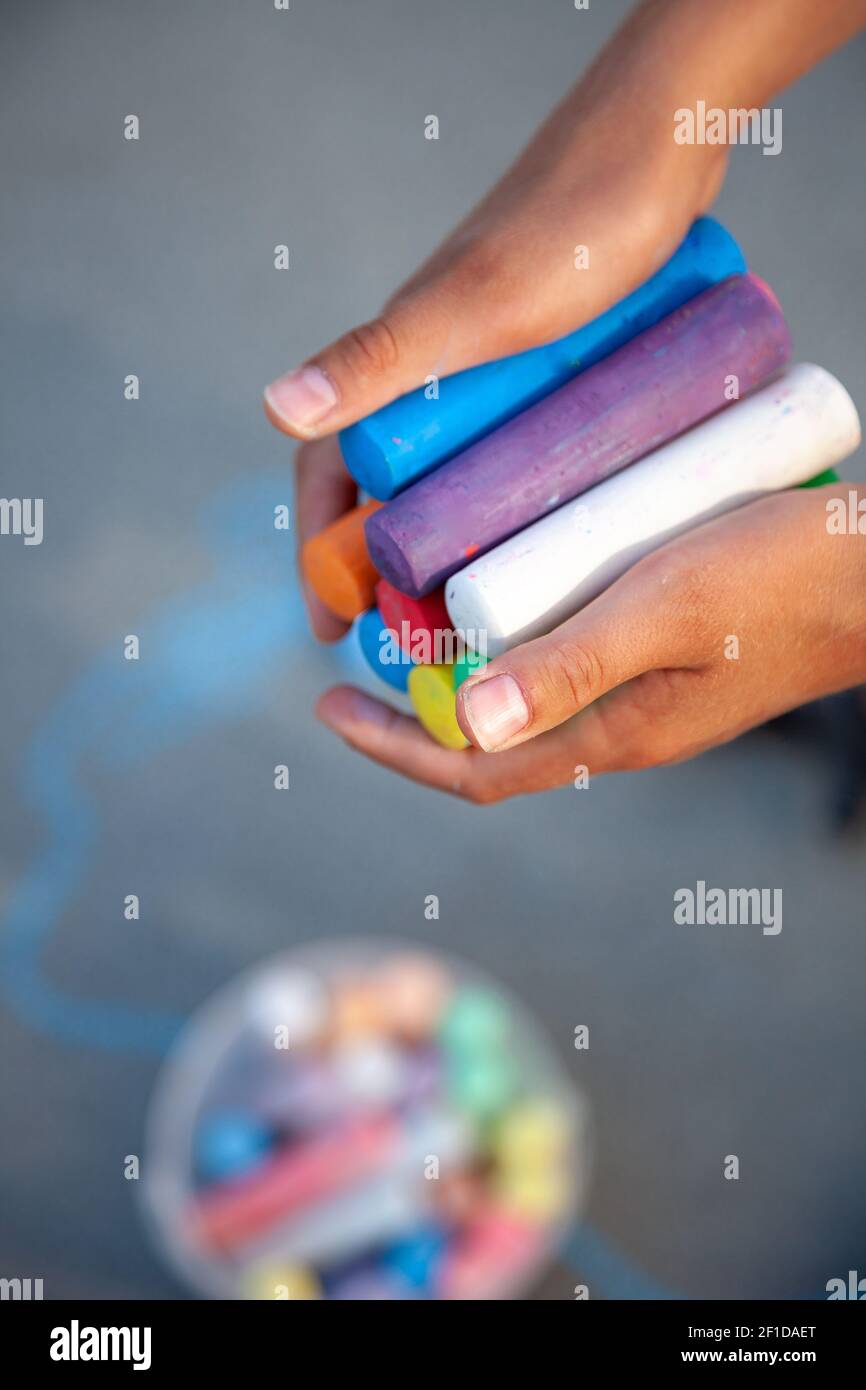Chalks. Large multi-colored crayons in children's hands. The child ...