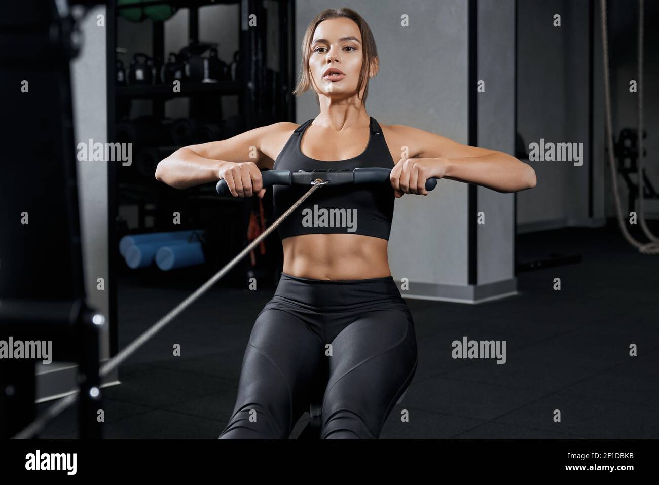 Top view of attractive woman in sports suit doing exercise with weight ...