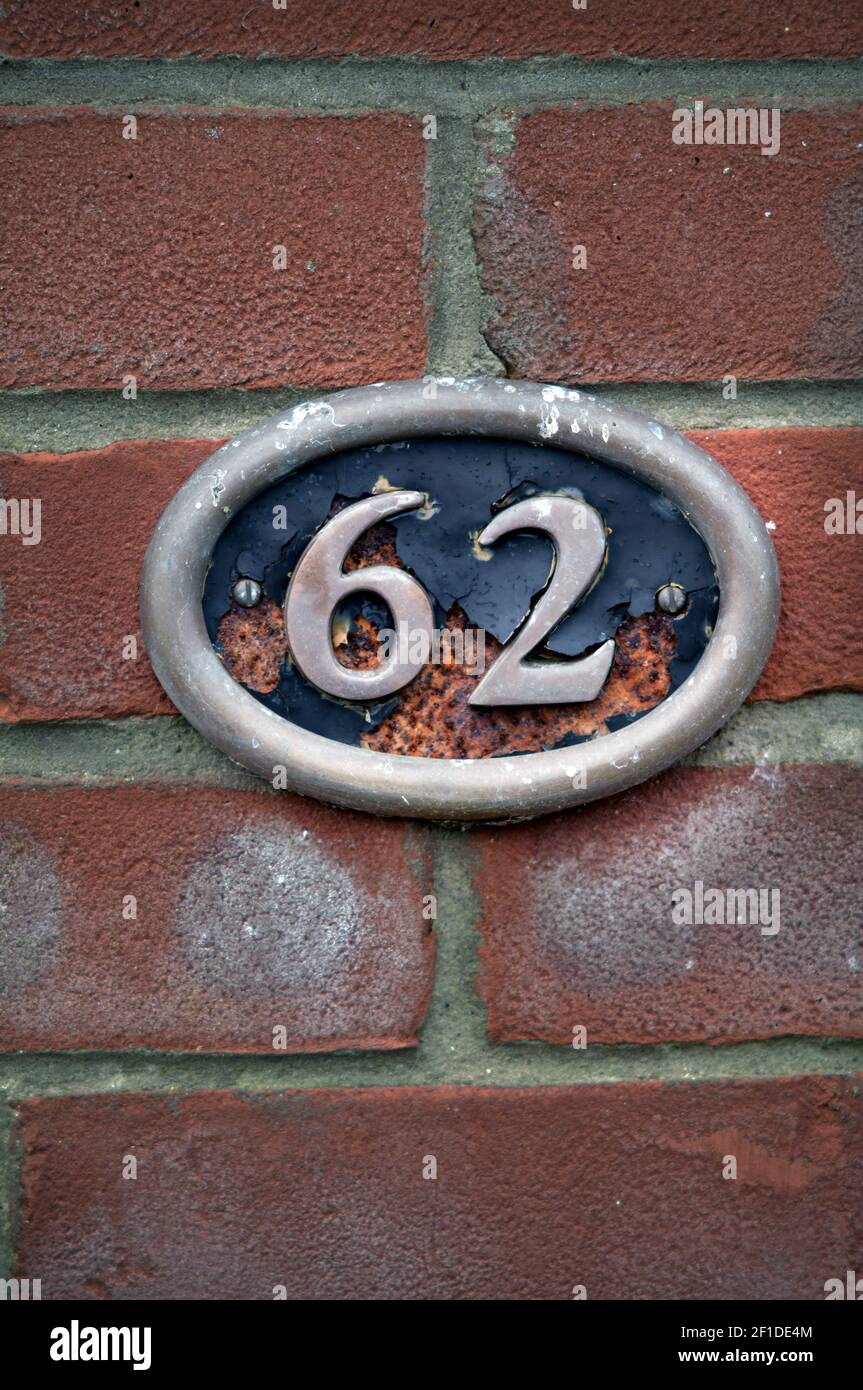 weathered house number plate Stock Photo - Alamy