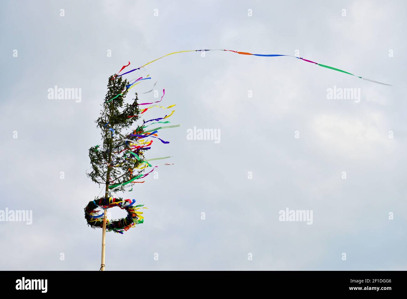 Maypole on a cloudy sky. Traditional European symbol of spring ...