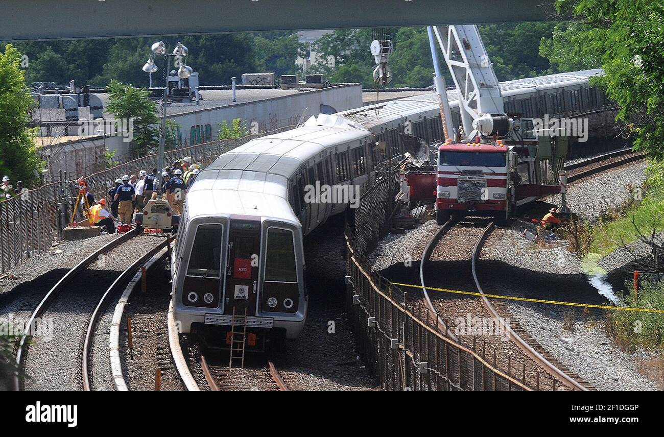 Investigators work at the site where two Red Line Metrorail trains ...