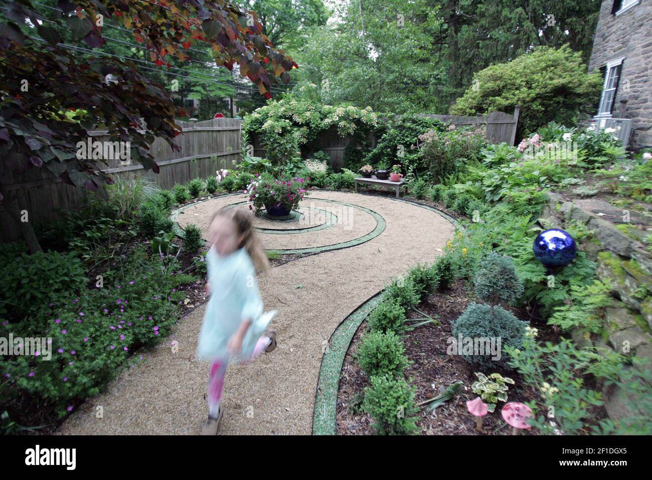 As Natalie Bauder skips through her garden, hair flying, light as a ...