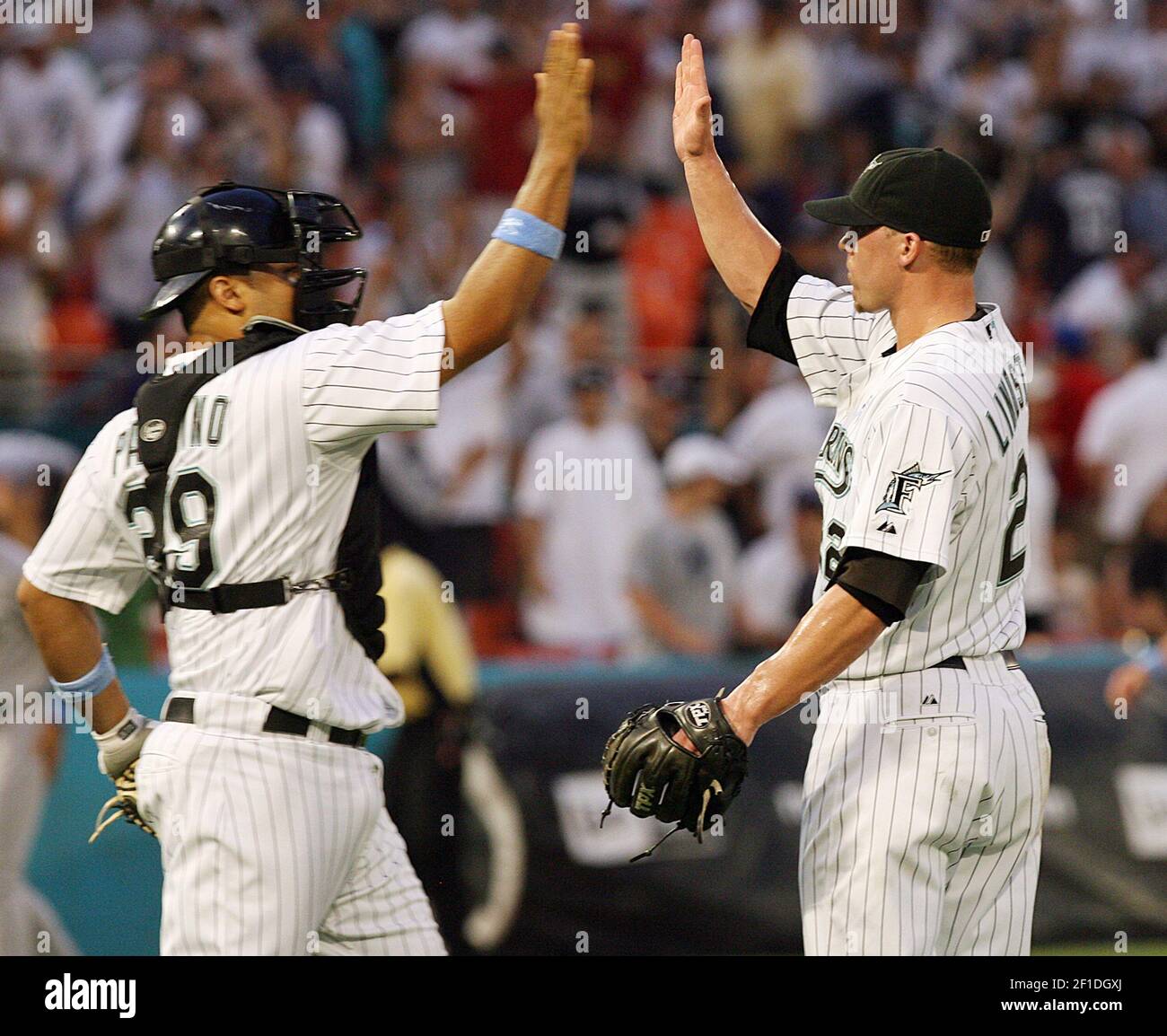 Florida Marlins catcher Ronny Paulino high five with pitcher Matt ...