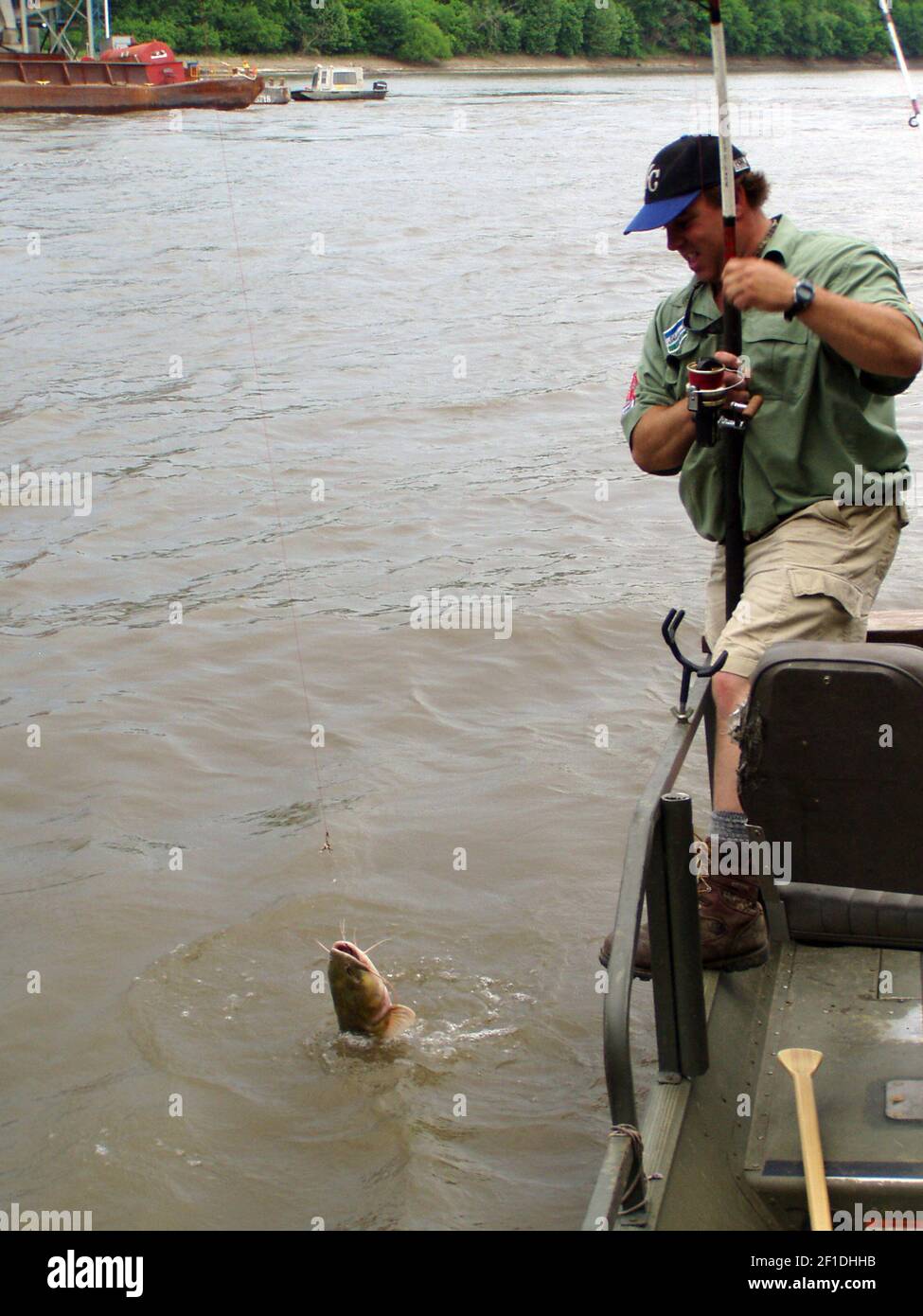 Captain Catfish, also known as John Trager, lands a flathead catfish on ...