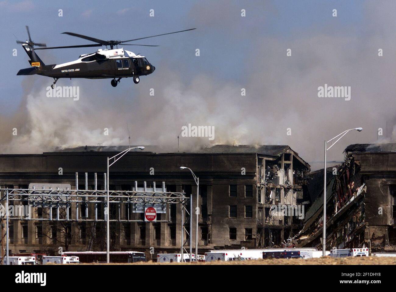 A military helicopter flies over the Pentagon after an airplane crashed ...