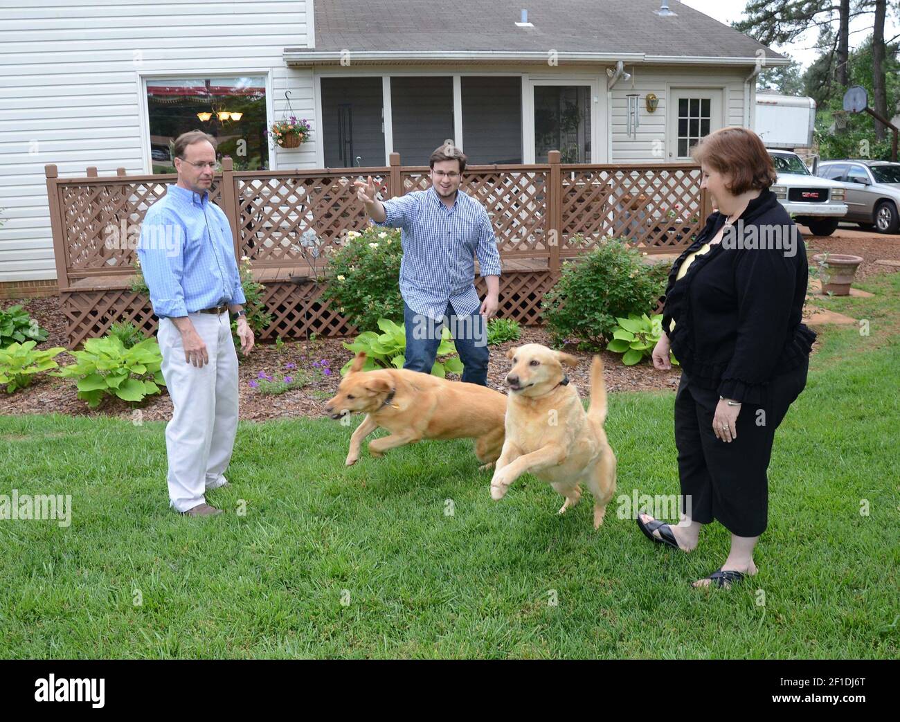 Brian Griffith, 26, center, moved home with his parents Jay, left, and ...