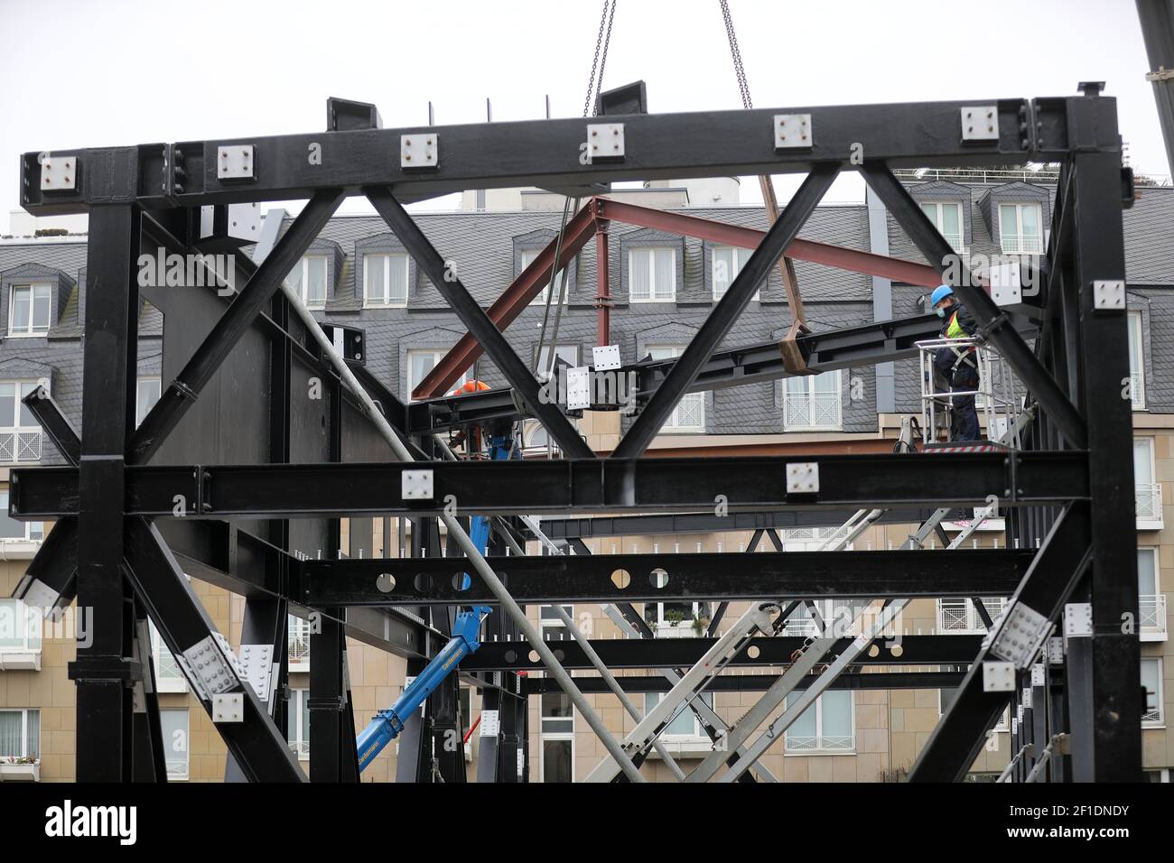 Cologne, Germany. 08th Mar, 2021. A crane hoists a steel roof pyramid ...