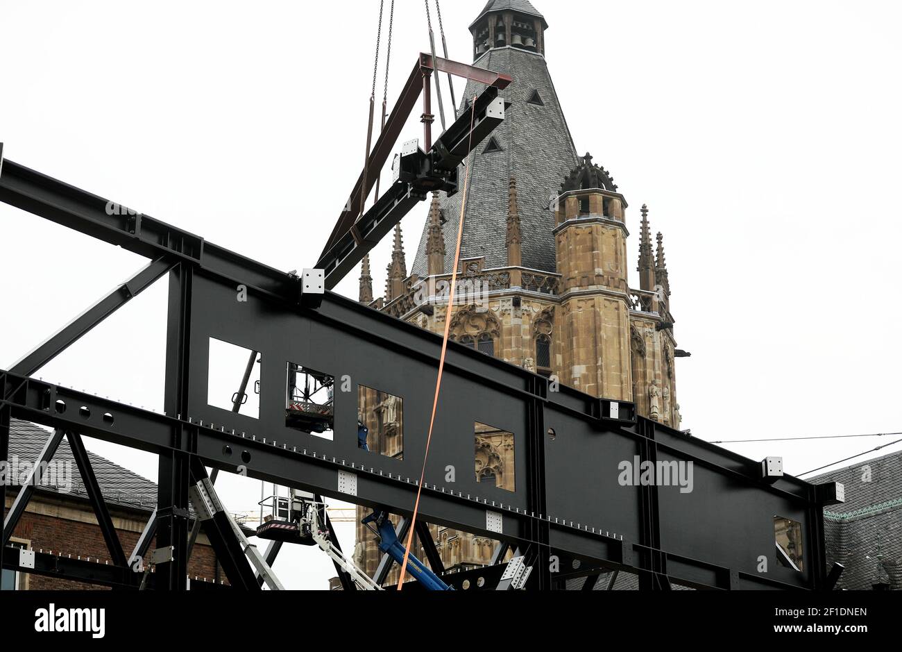 Cologne, Germany. 08th Mar, 2021. A crane hoists a steel roof pyramid ...