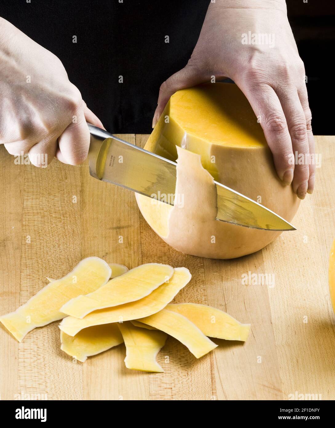 Peeling squash: Place the knife blade at the top of the squash, just ...