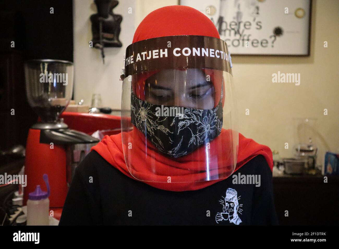 A employee wears face shield as preventive measure, at the Atjeh ...