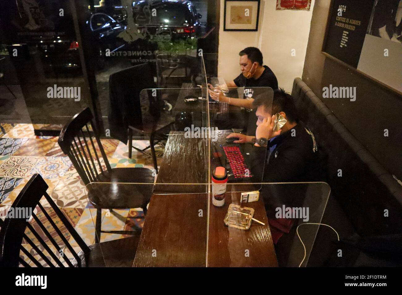 Customers dines in behind an acrylic separator at the Atjeh Connection ...
