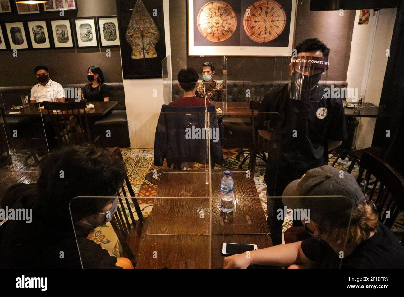 Customers dines in behind an acrylic separator at the Atjeh Connection ...