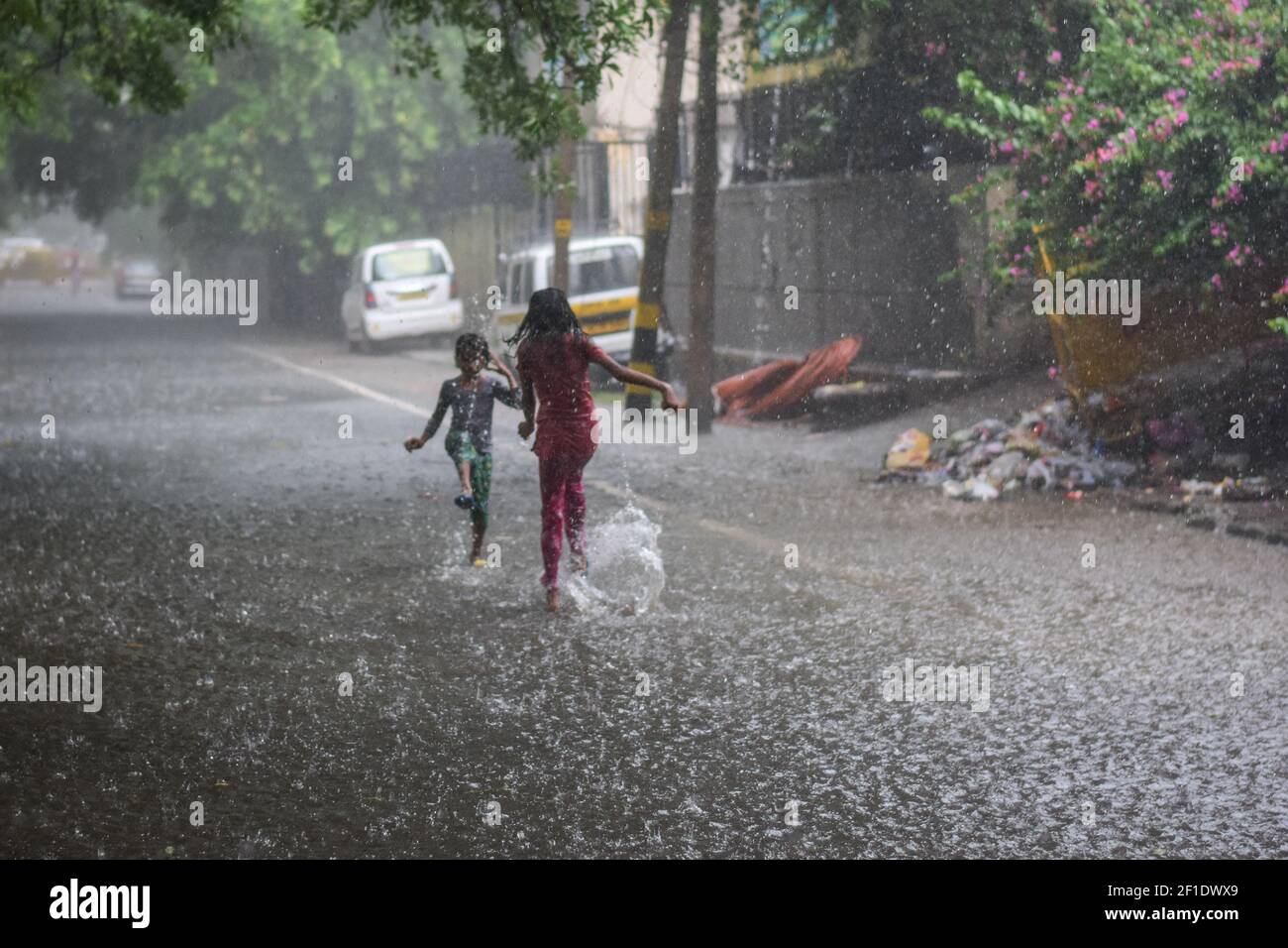 Kids seen playing in the rain, during heavy rainfall in Delhi. Heavy ...