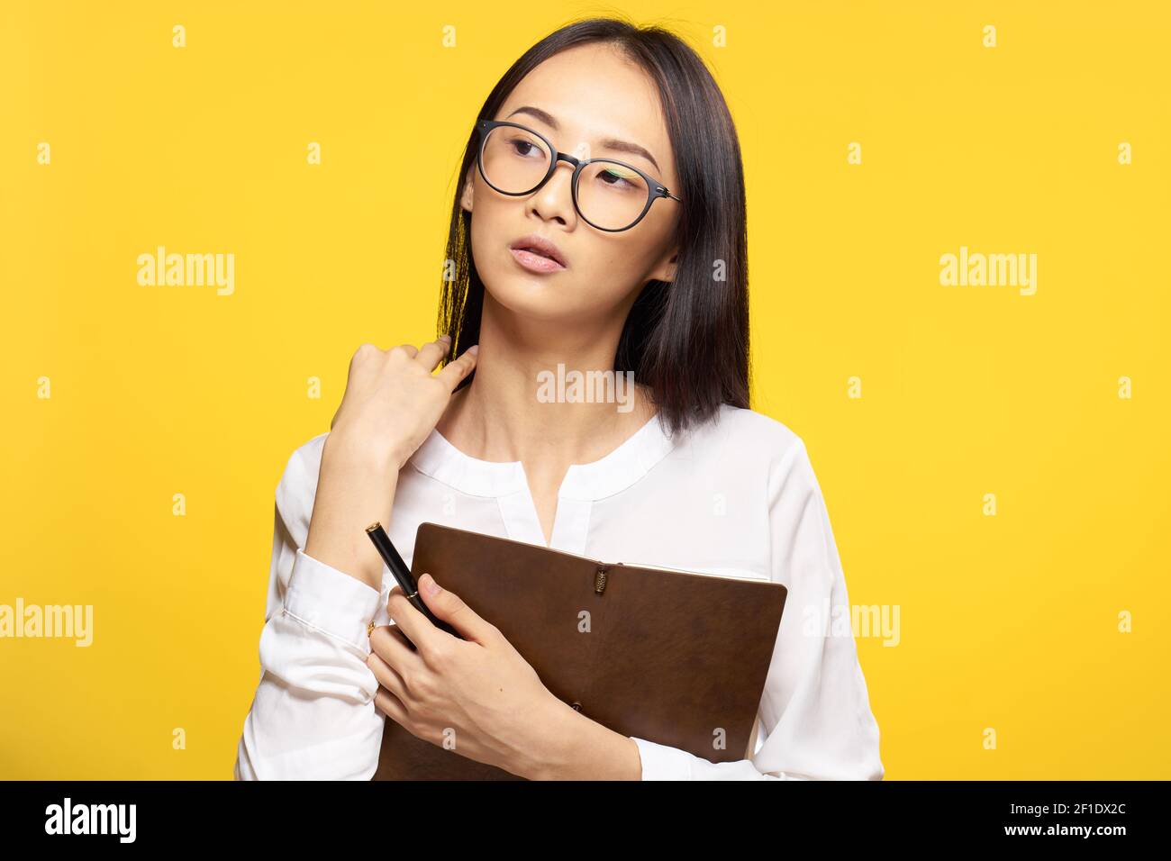 elegant woman with notepad in hands official office yellow isolated ...