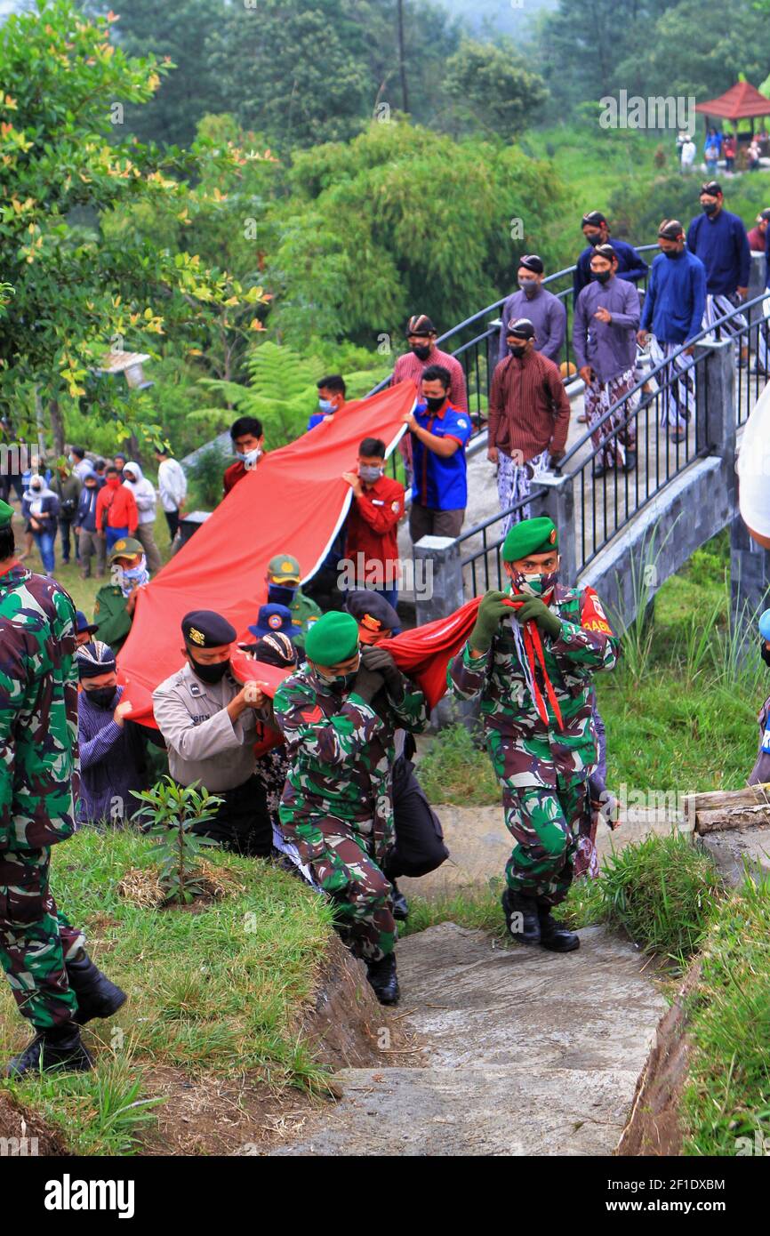 Indonesian National Army (TNI) and residents wearing traditional ...