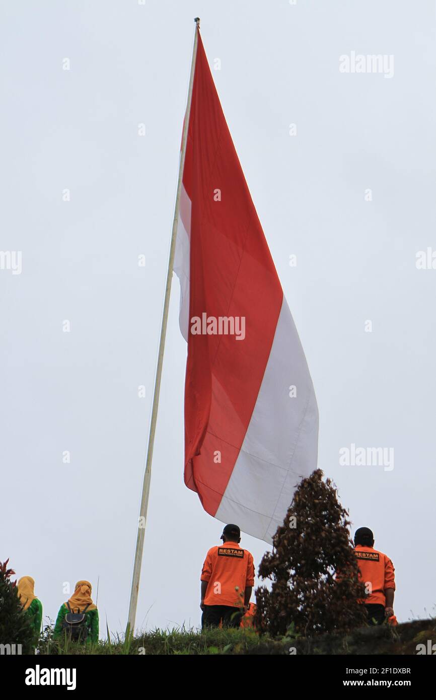 Indonesian Army (TNI) and residents during a flag ceremony ahead of the ...