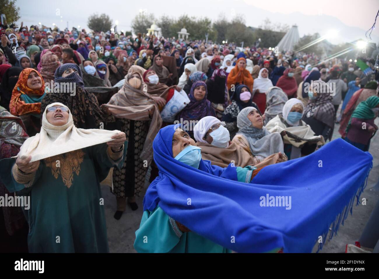 Kashmiri Muslim devotees raise their hands while beseeching for ...