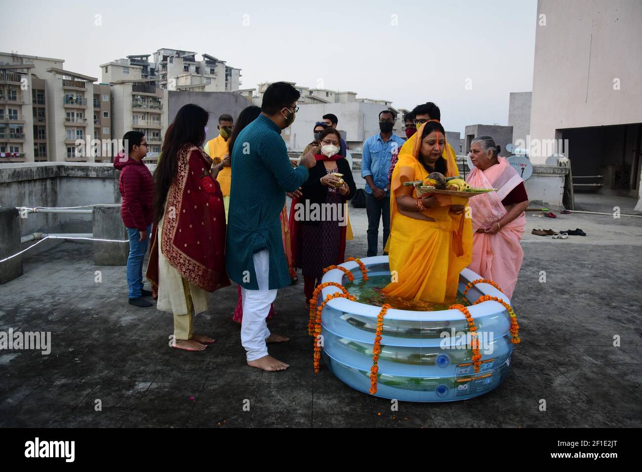 A Hindu devotee stands inside a bath tub full of water as she performs ...
