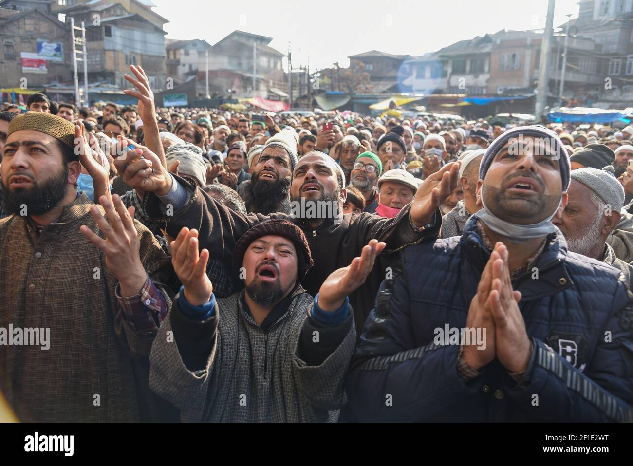 Kashmiri Muslim devotees raise hands while beseeching for blessings as ...