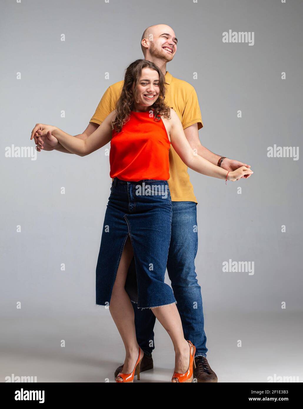 White european young people isolated on gray dancing Stock Photo - Alamy