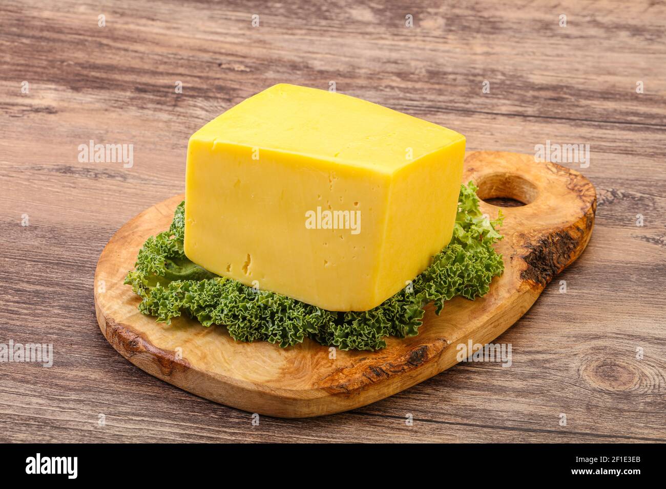 Yellow tilsiter cheese dairy product brick Stock Photo - Alamy